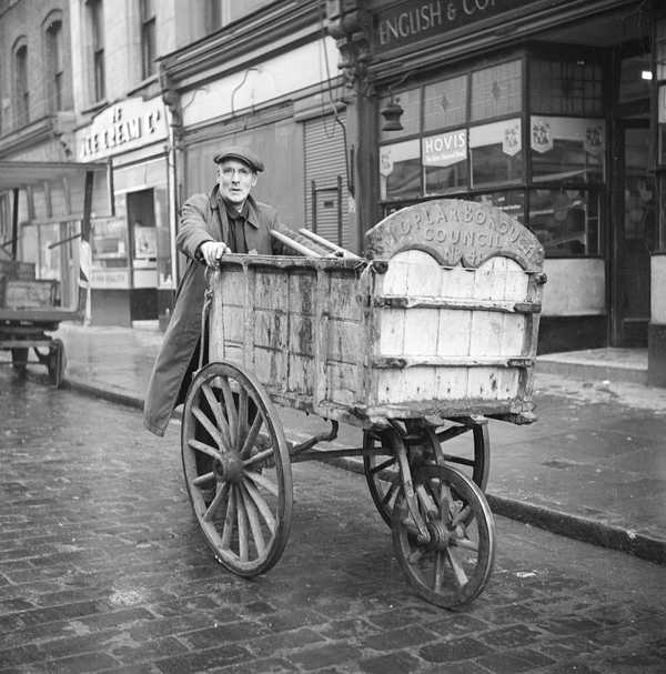 Photograph showing a street cleaner with a cart‘, Nigel Henderson, [c ...