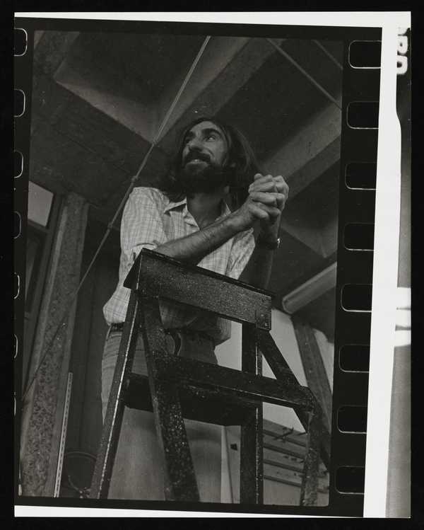 Black and white photograph of Ian Breakwell standing on a ladder in ...