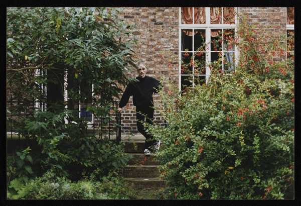 Colour photograph of Ian Breakwell in the garden of the flat where he ...