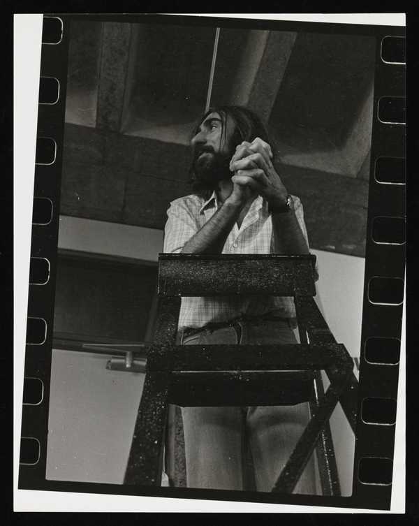 Black and white photograph of Ian Breakwell standing on a ladder in ...