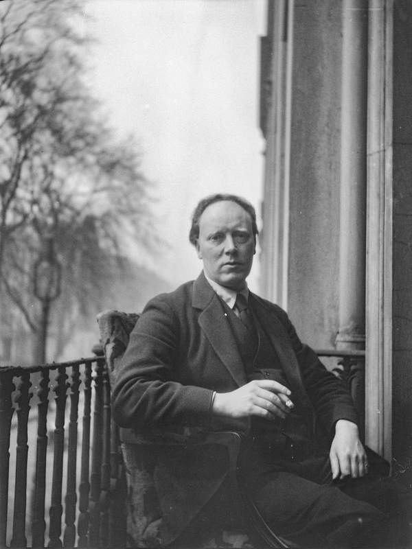Black and white negative of Clive Bell, seated on a balcony and smoking ...