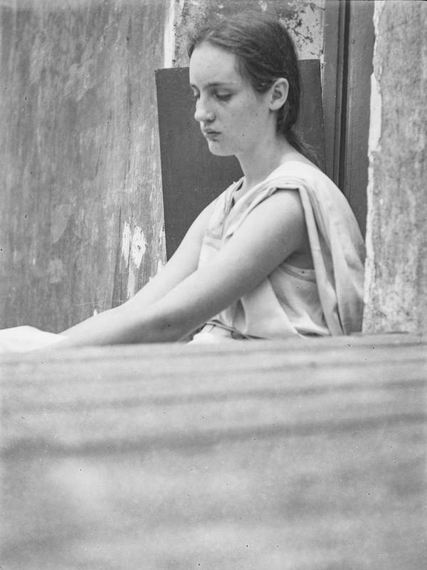 Black and white negative of Angelica Bell seen in profile looking down ...