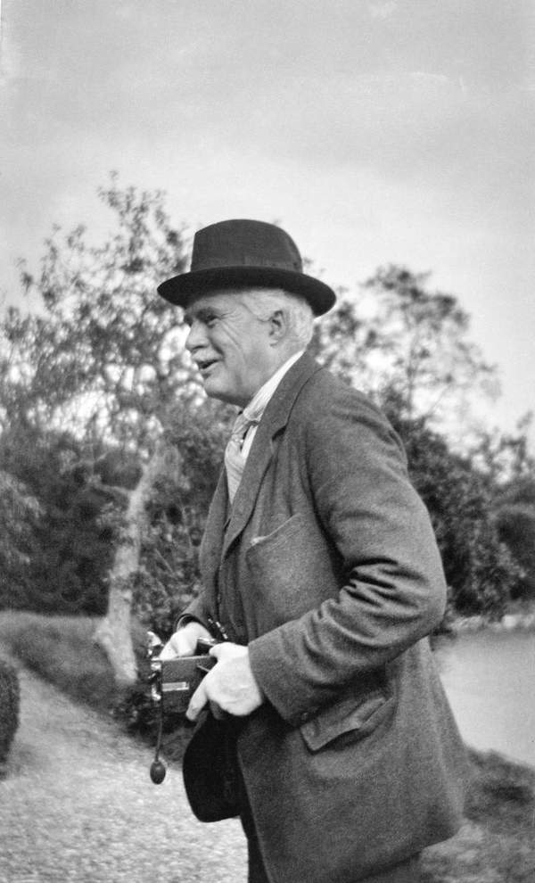 Black and white negative of George Herbert Duckworth holding a camera ...