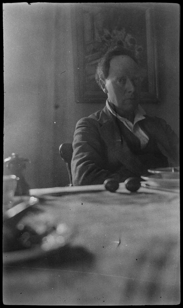 Black and white negative of Clive Bell seated a table at Charleston ...