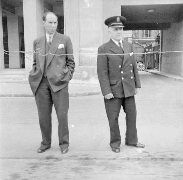 Photograph of two unidentified men standing behind a rope‘, Nigel ...