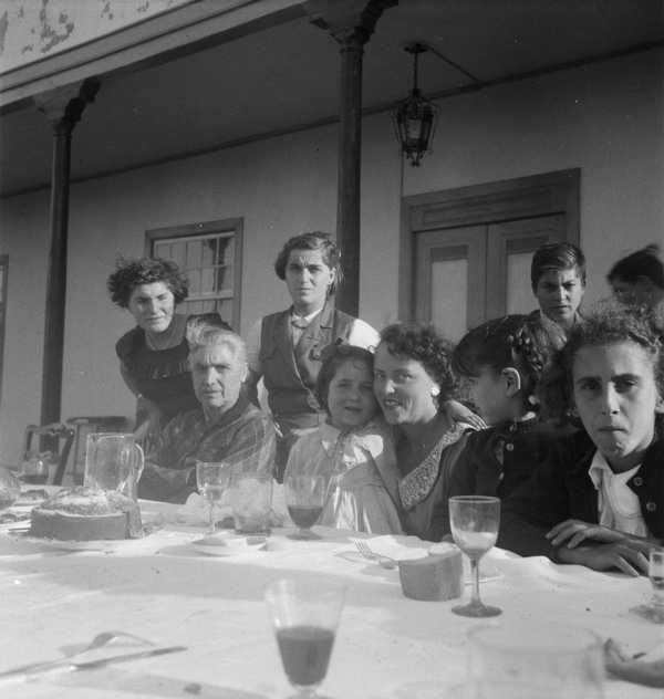 Photograph of Mollie Gordon with a group of friends sitting at a table ...