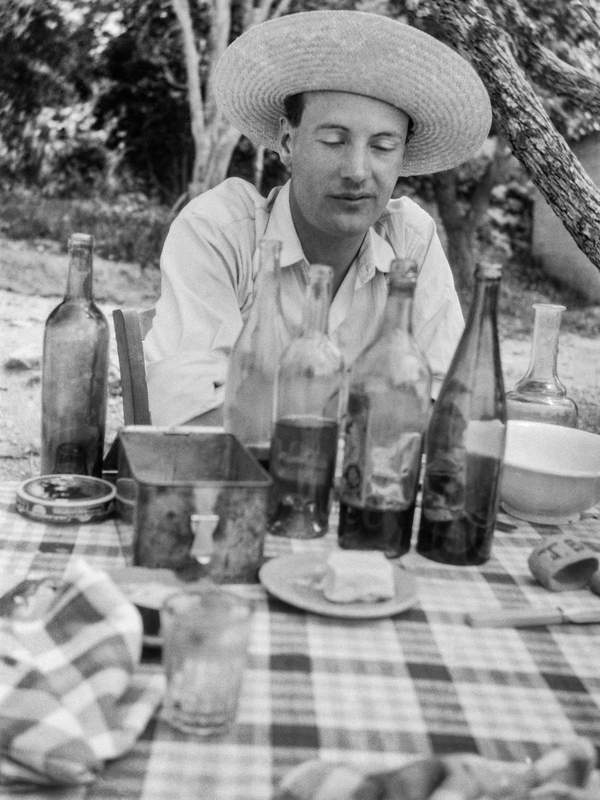 Black and white negative of Angus Davidson seated at a table at La ...
