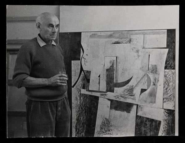 Photographs of Ben Nicholson standing next his work in his studio in ...