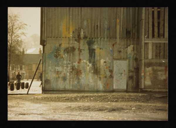 Colour photograph of a wall covered in paint splashes in Northern ...
