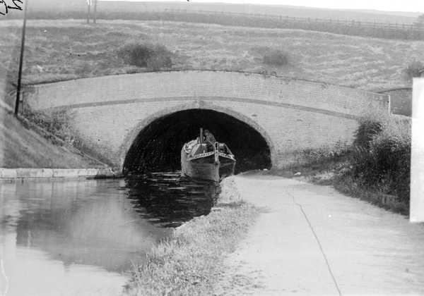 Photograph showing a barge underneath a bridge on a canal‘, Anonymous ...
