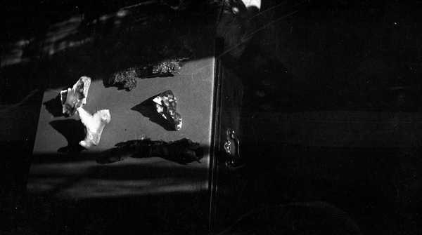 Black and white negative, still life, flints and shadows on a doormat ...