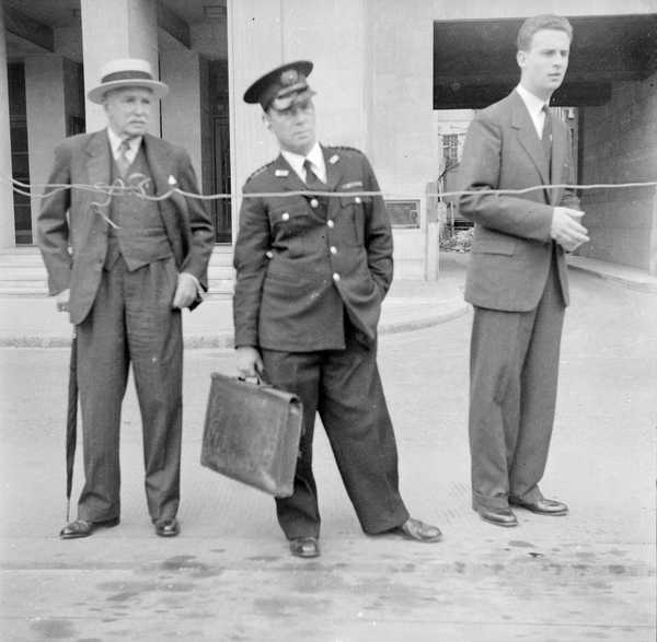 Photograph of three unidentified men standing behind a rope‘, Nigel ...