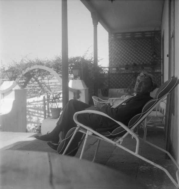 Photograph of Joseph Bard sitting on a reclining chair on the terrace ...