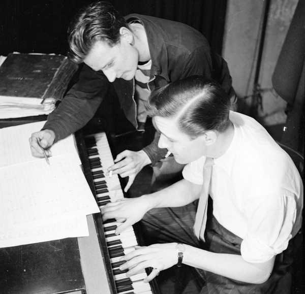 Photograph of Jack Parnell performing on piano with an unidentified man ...