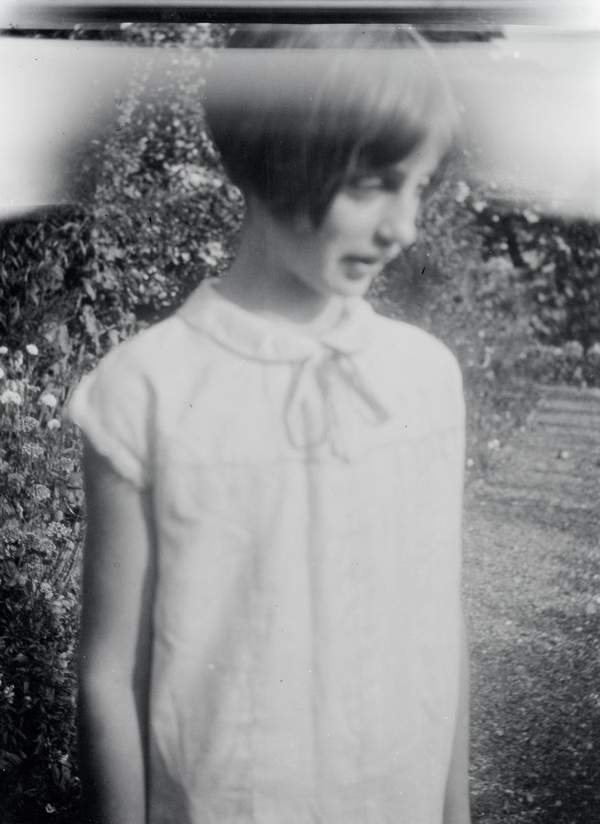 Black and white negative of Angelica Bell wearing a dress with a bow ...