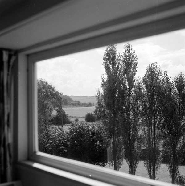 Photograph of a view of a countryside landscape through a window ...