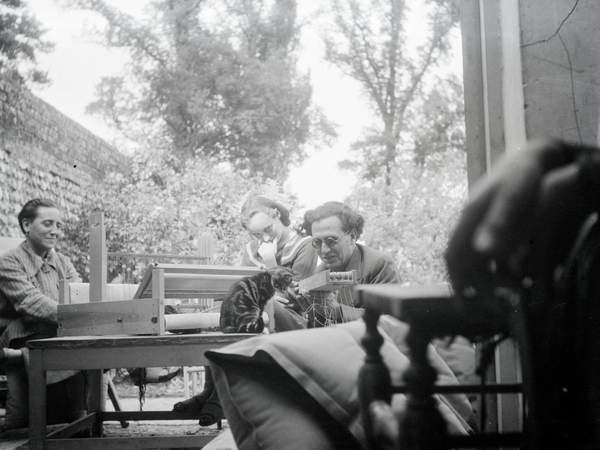 Black and white negative of Marie Mauron, Angelica Bell and Charles Mauron seated at a table ...
