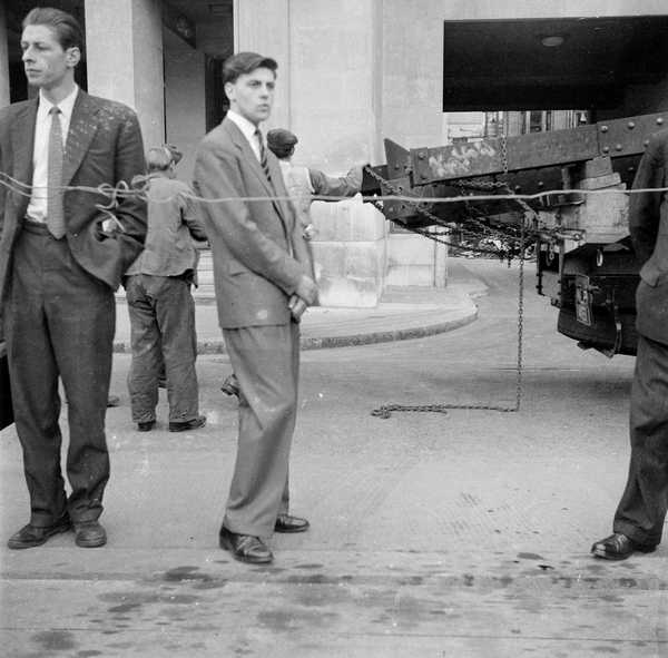Photograph showing a group of men standing behind a rope‘, Nigel ...