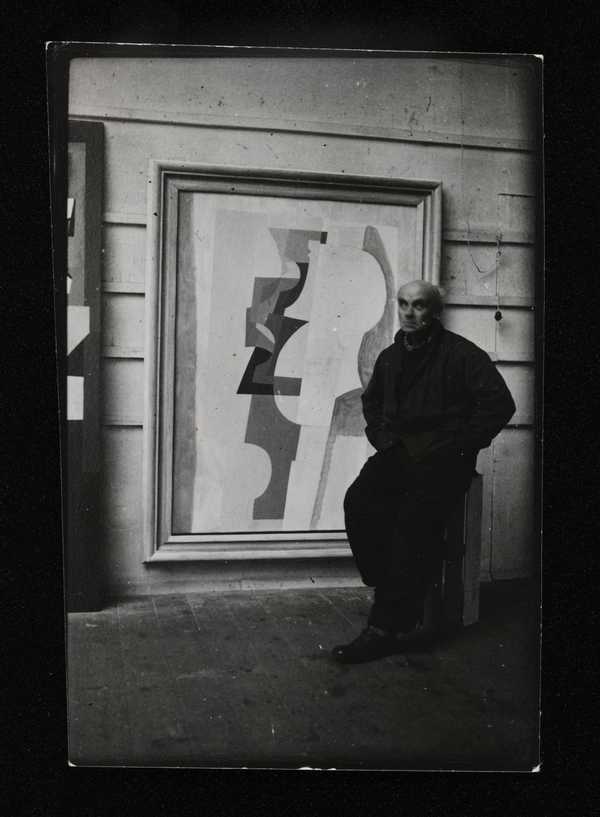 Photograph of Ben Nicholson standing next to his ‘1953 February ...