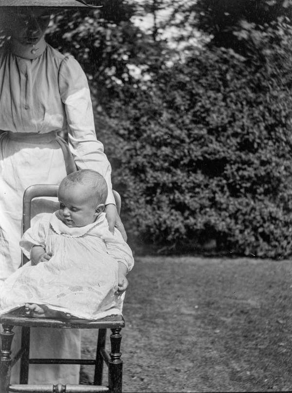 Black and white negative of Quentin Bell seated on a chair outside with ...