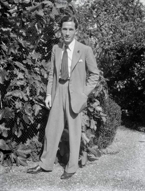 Black and white negative of George Bergen standing in the garden at ...