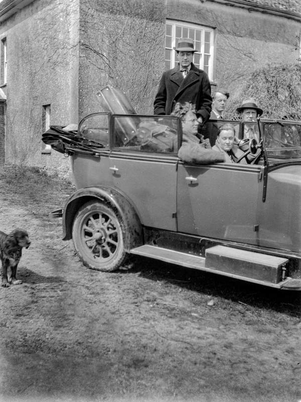 Black and white negative of a group in a car with a dog [pinska] at ...