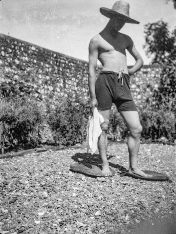 Black and white negative of Angus Davidson wearing a wide brimmed sun ...