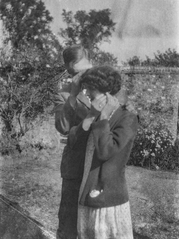 Black and white negative of David Garnett talking closely to Barbara ...