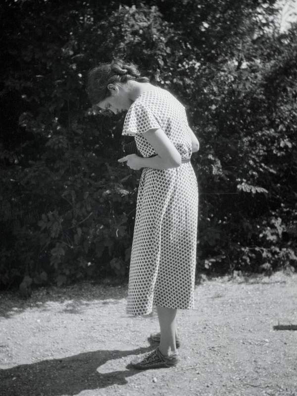 Black and white negative of Angelica Bell seen from profile, taking a ...