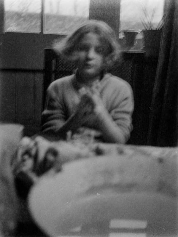 Black and white negative of Elizabeth Wellesley working with clay on a ...