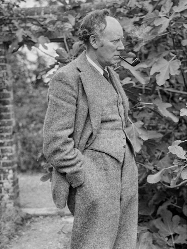 Black and white negative of Clive Bell smoking with a pipe, standing in ...