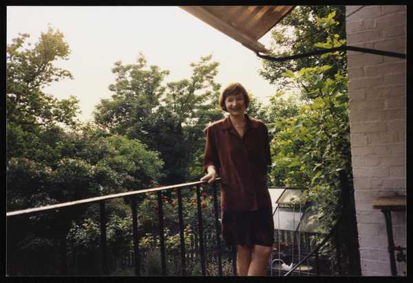 Colour photograph of Eva Adler standing on the balcony of 6 Chesterford ...