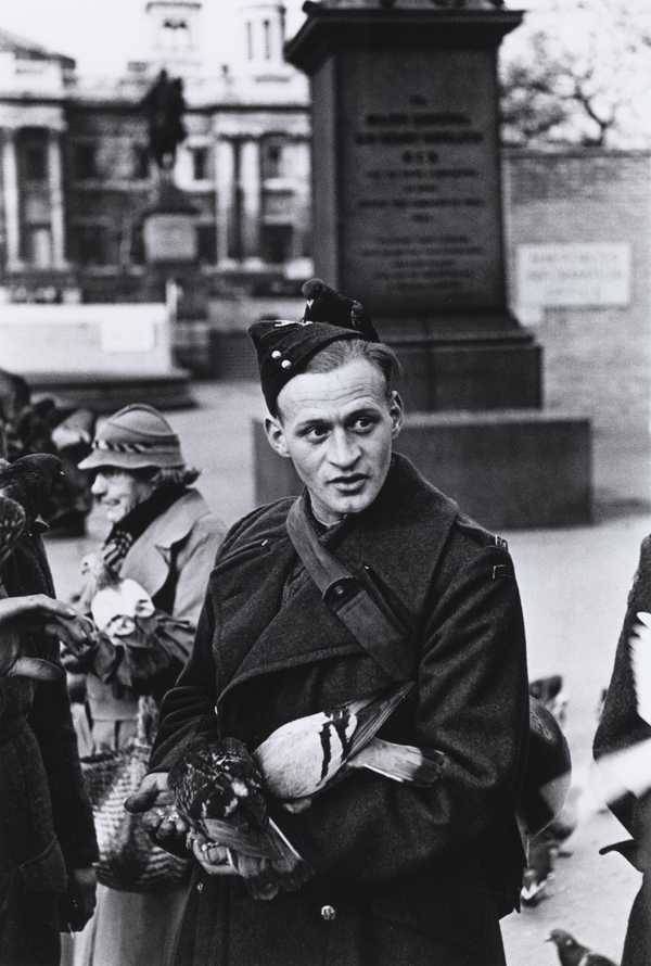 ‘A soldier on leave feeds the pigeons in Trafalgar Square, London ...