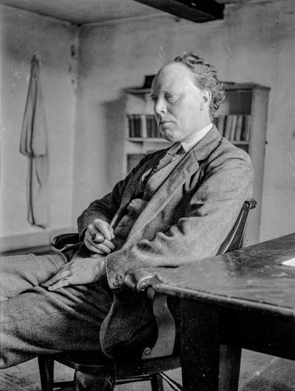 Black and white negative of Clive Bell seated with a pipe indoors at ...